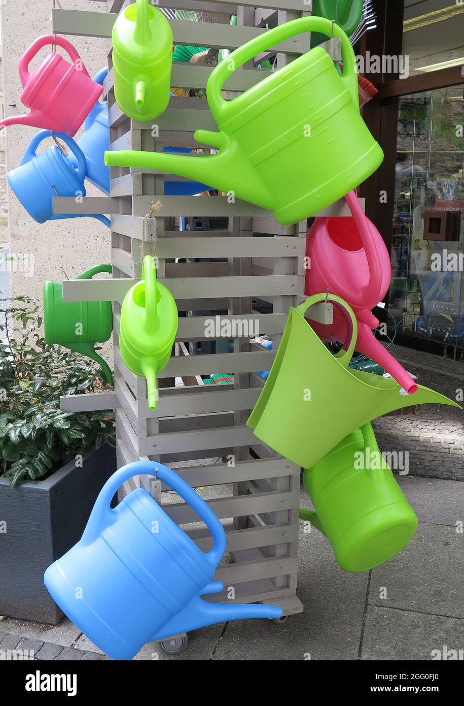 Collection of colorful plastic watering cans for sale Stock Photo - Alamy