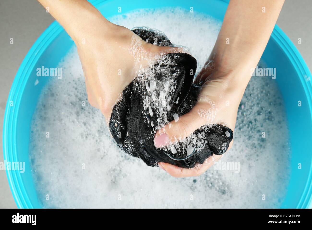 Female hands washing clothes in basin Stock Photo - Alamy