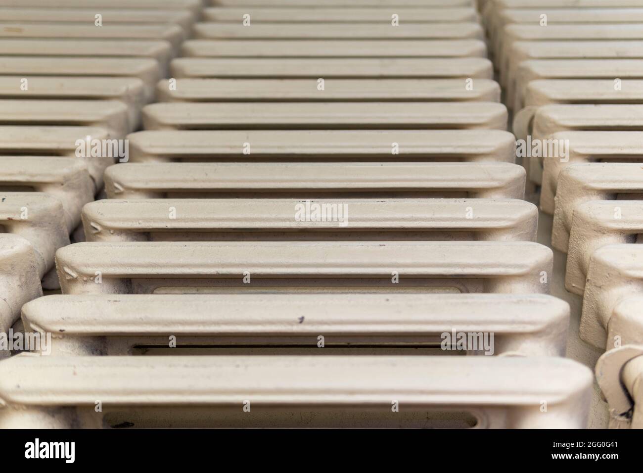 Old painted heating radiator. Pink dirty color. View from the front ...