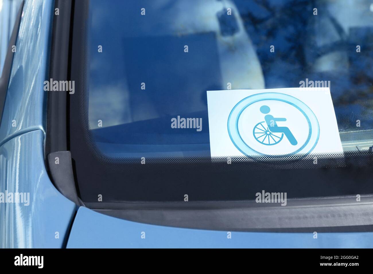 Symbol of handicapped on car windshield, closeup Stock Photo - Alamy