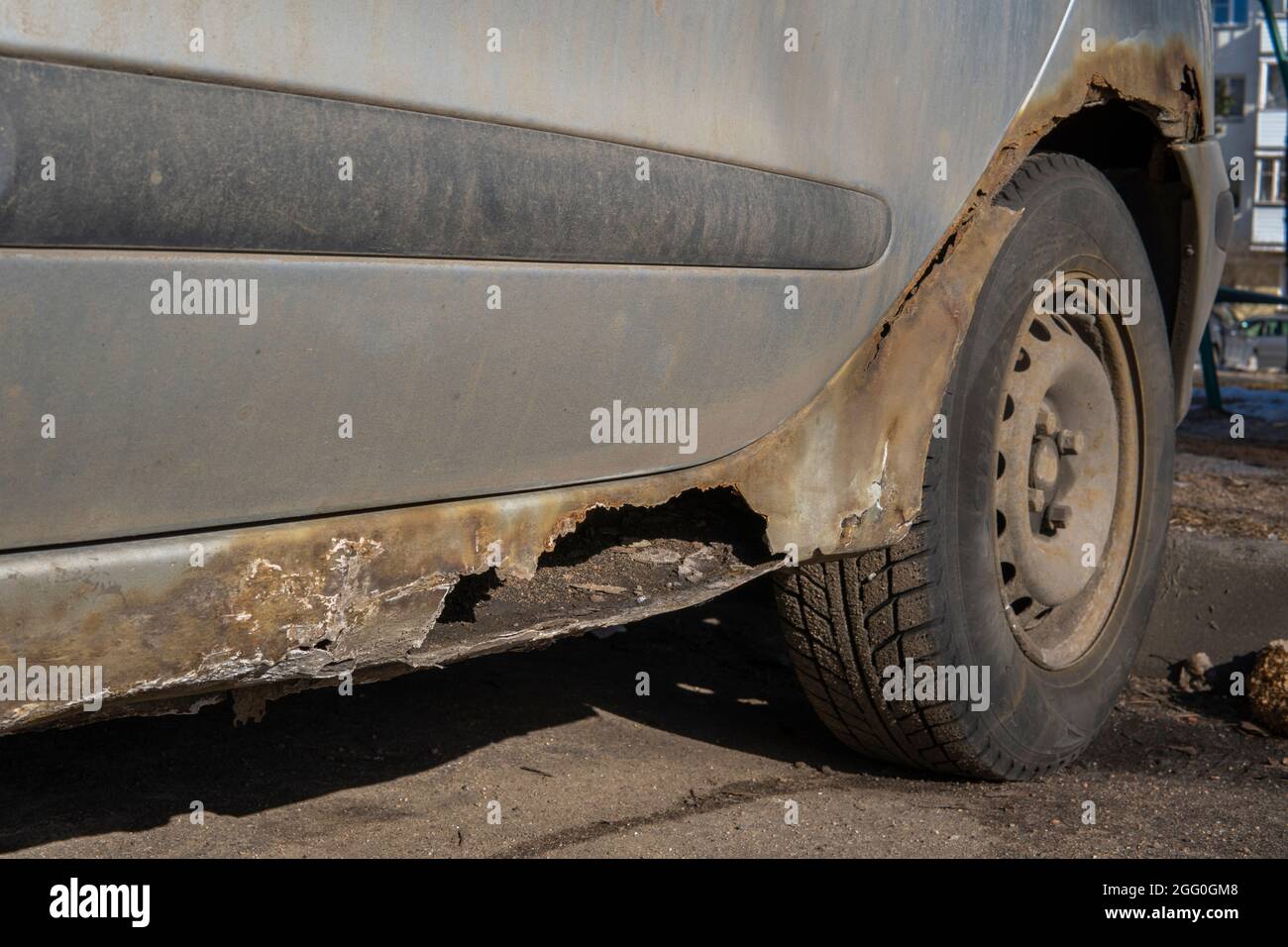 Rusty and dirty car door damaged by corrosion. Hole in the door car ...