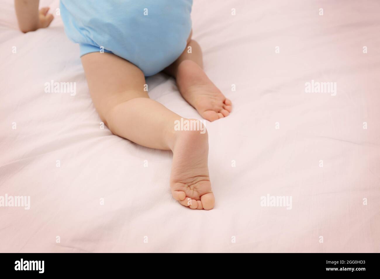 Little baby legs on bed, closeup Stock Photo - Alamy