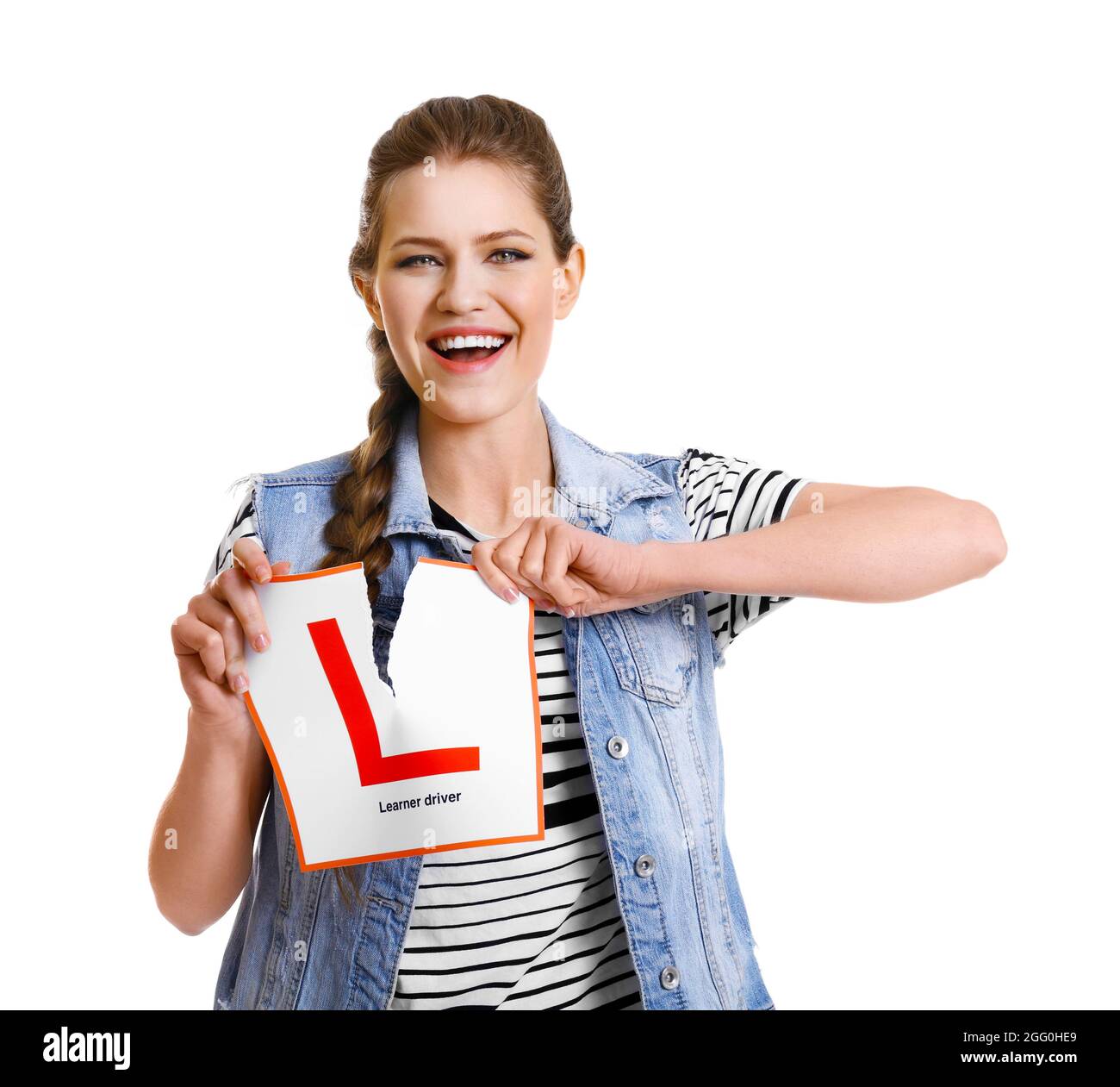 Young woman tearing learner driver sign on white background Stock Photo ...
