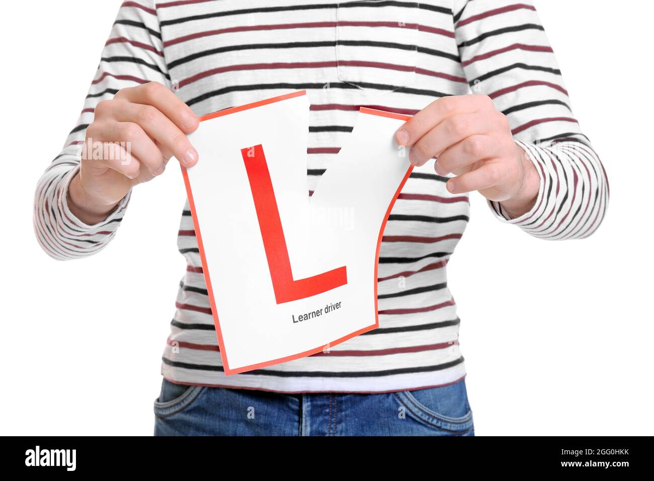 Young man tearing learner driver sign on white background, closeup ...