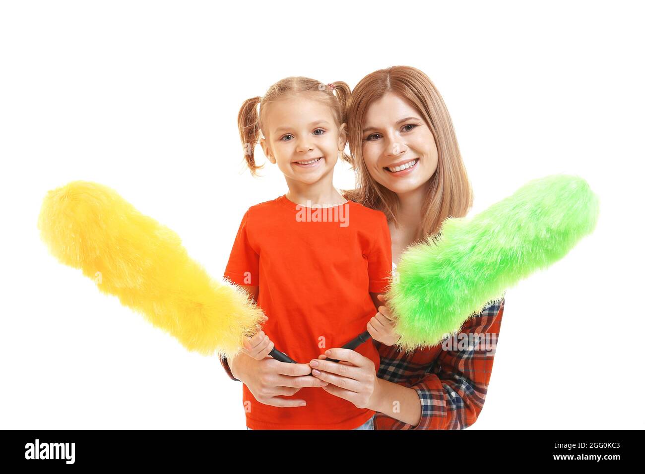 Little girl and her mother with dusters on white background Stock Photo ...