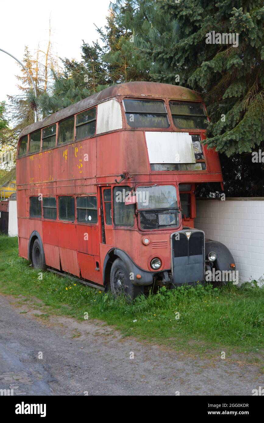 Vertical shot of an old abandoned red double-decker bus Stock Photo - Alamy