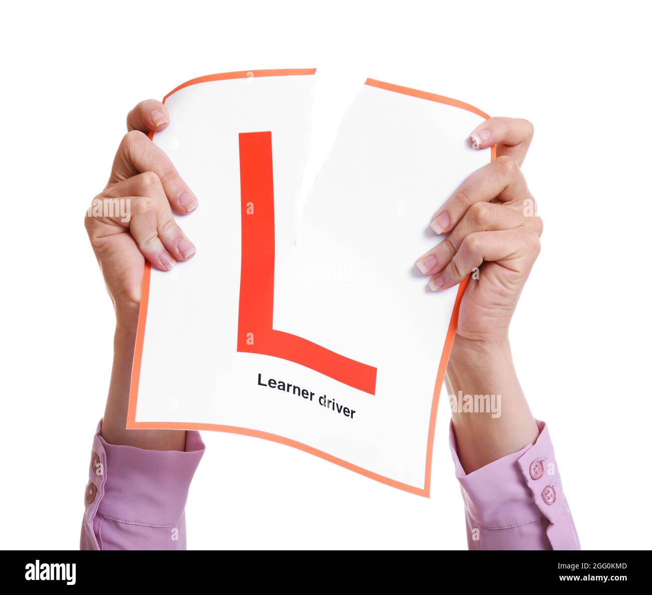 Hands of young woman tearing learner driver sign on white background ...