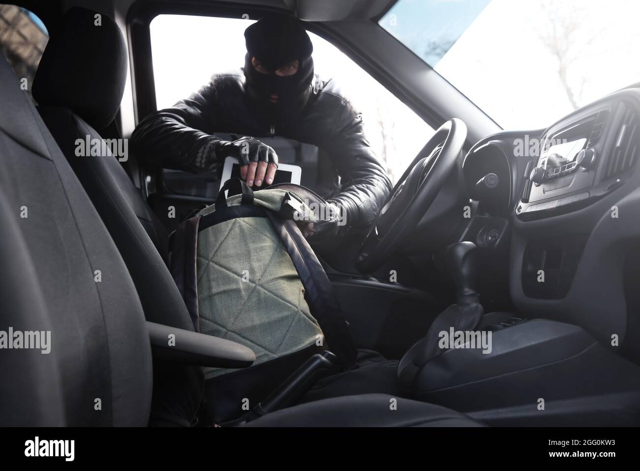 Thief stealing tablet from car Stock Photo - Alamy