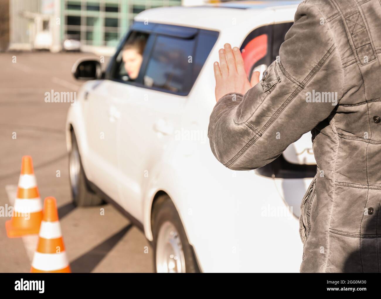 Instructor and woman passing driving license exam outdoors Stock Photo ...