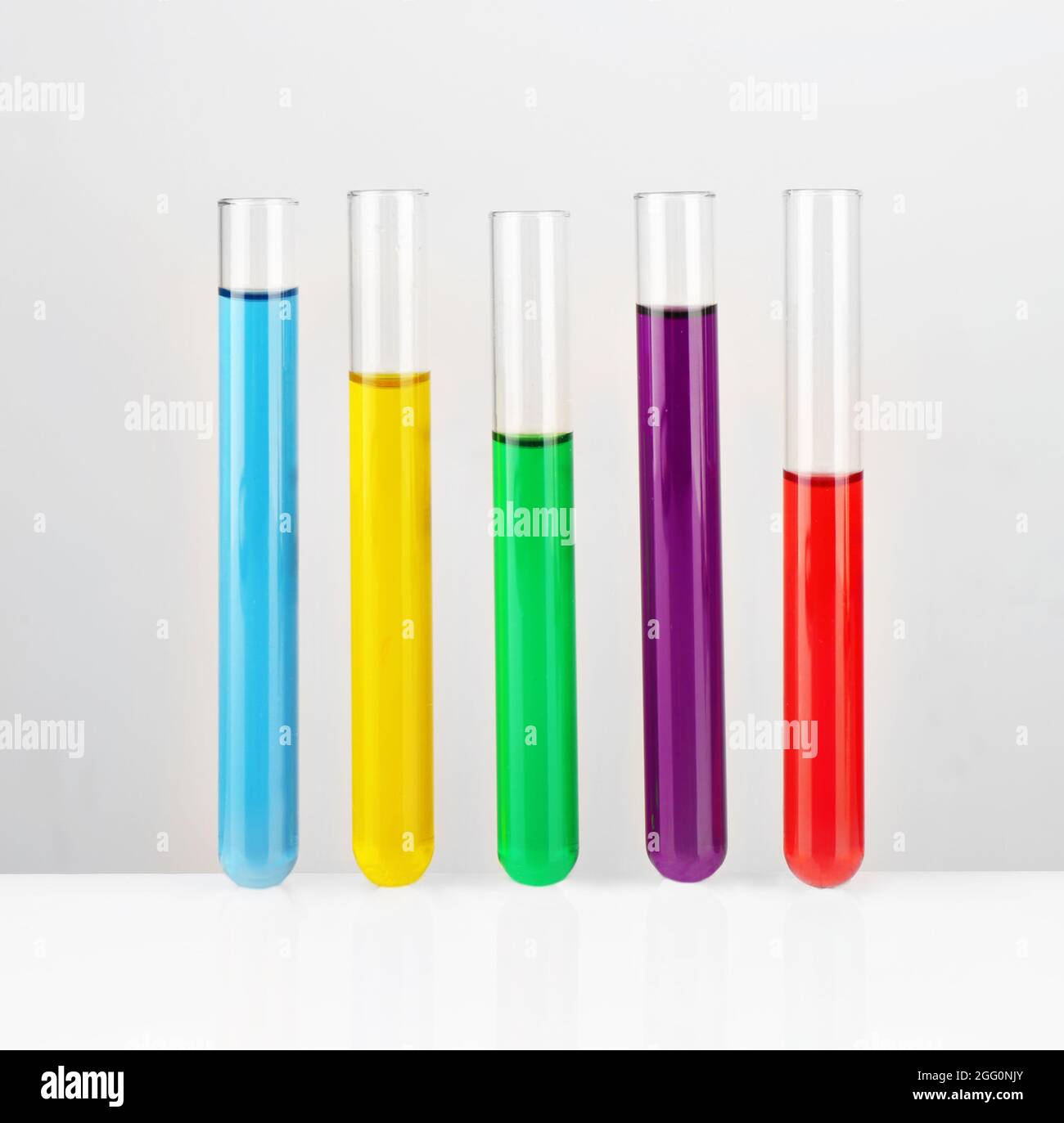 Test tubes with colourful samples on white background Stock Photo - Alamy