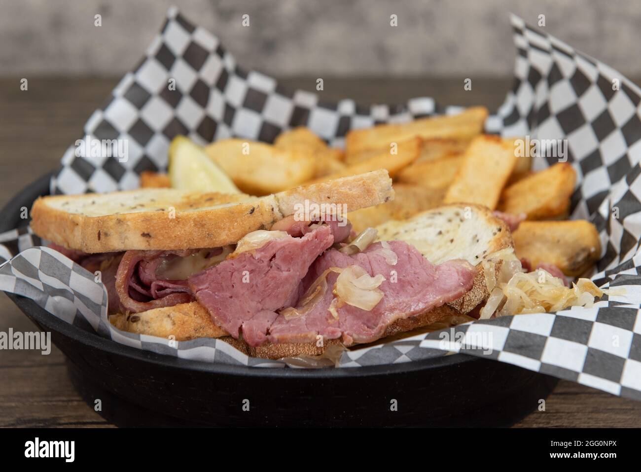 Reuben sandwich with corned beef on grilled rye bread served with steak ...