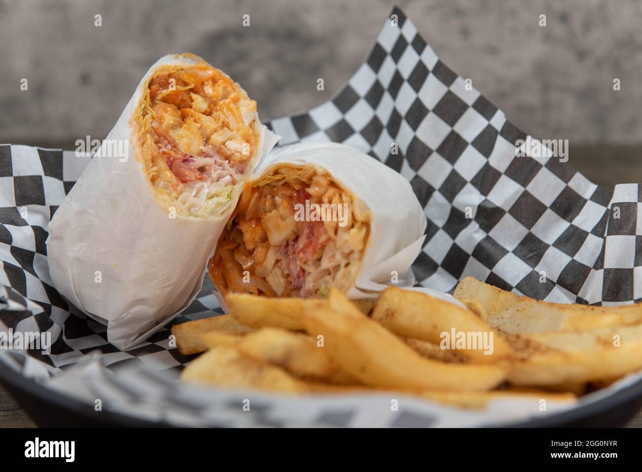 Hearty spicy chicken wrap loaded with ingredients and served with steak ...