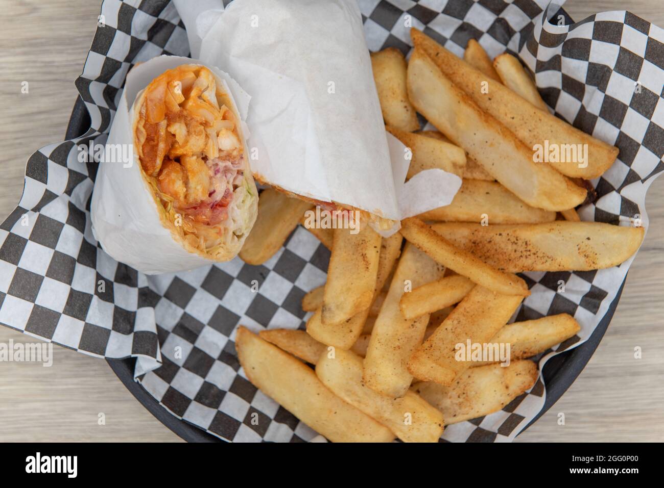 Overhead view of hearty spicy chicken wrap loaded with ingredients and ...