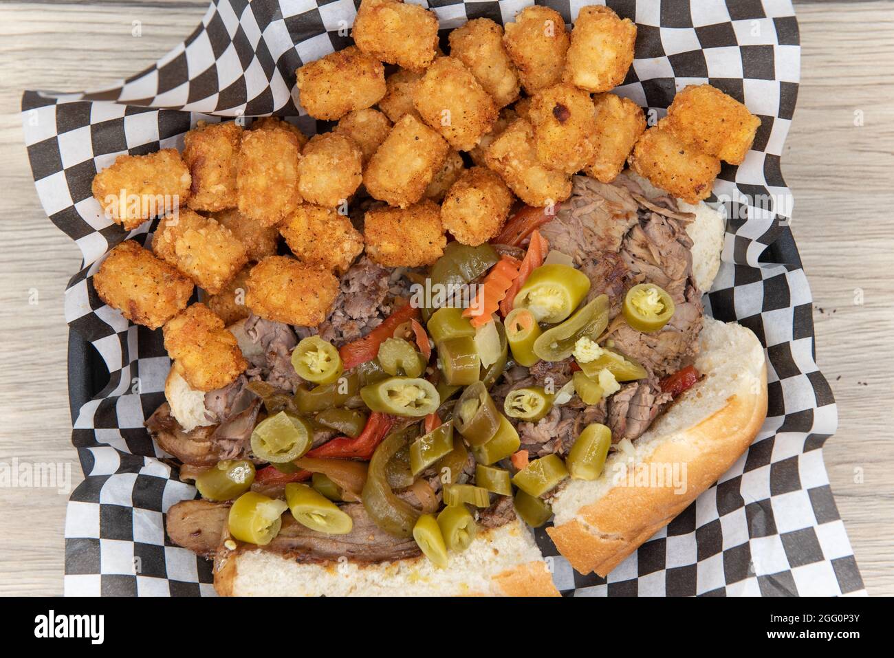 Overhead view of enormous open faced sandwich loaded with meat, tater ...