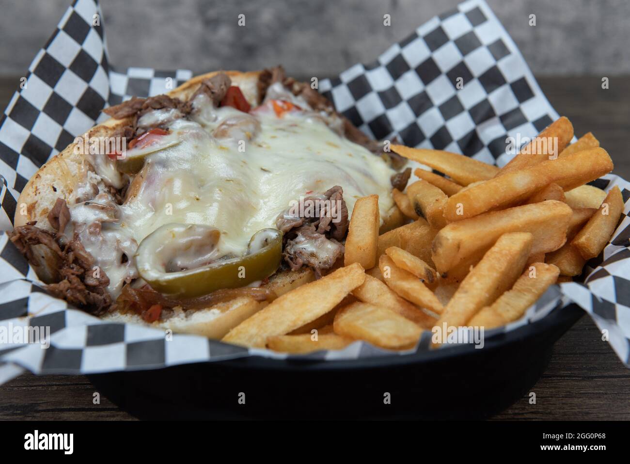 Open faced Philly cheesesteak sandwich smothered in meled cheese served ...