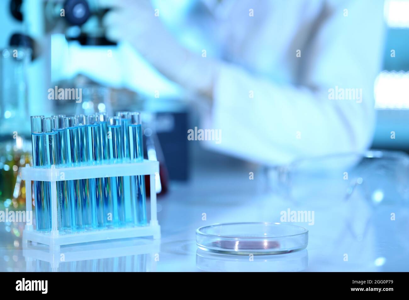 Test tubes with blue samples on laboratory background Stock Photo - Alamy