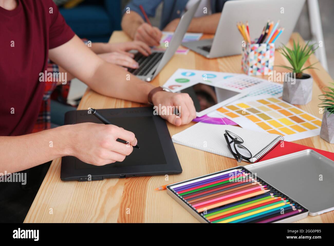 Group of young designers working at new project Stock Photo - Alamy