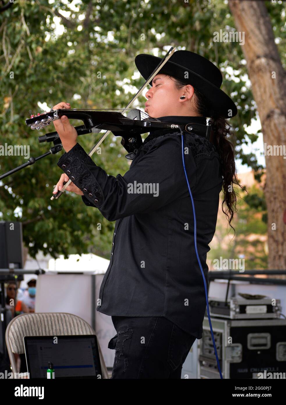 Native American musician Sage Cornelius plays his electrified violin at ...