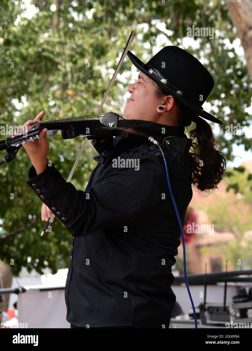Native American musician Sage Cornelius plays his electrified violin at ...