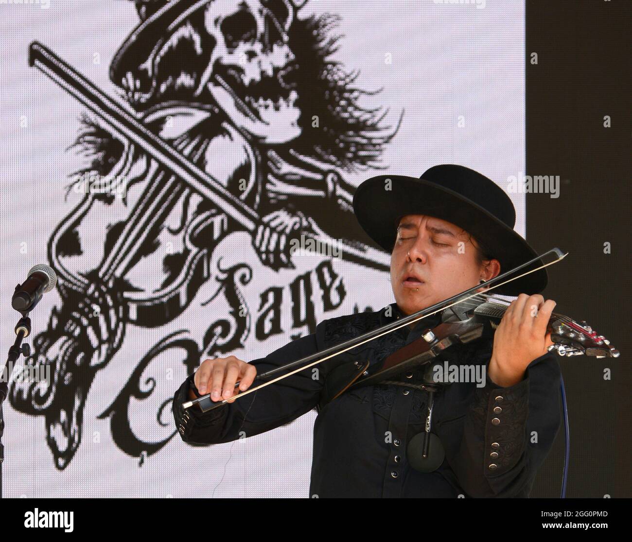Native American musician Sage Cornelius plays his electrified violin at ...