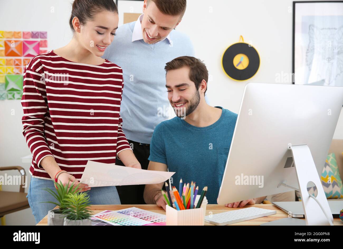 Group of young designers at workplace Stock Photo - Alamy