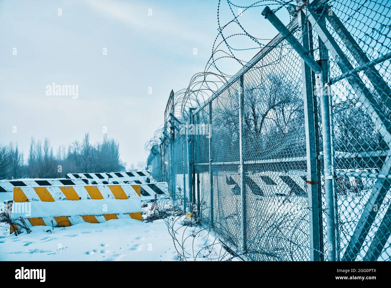 Barbed wire fence on border in winter. Private object near highway ...