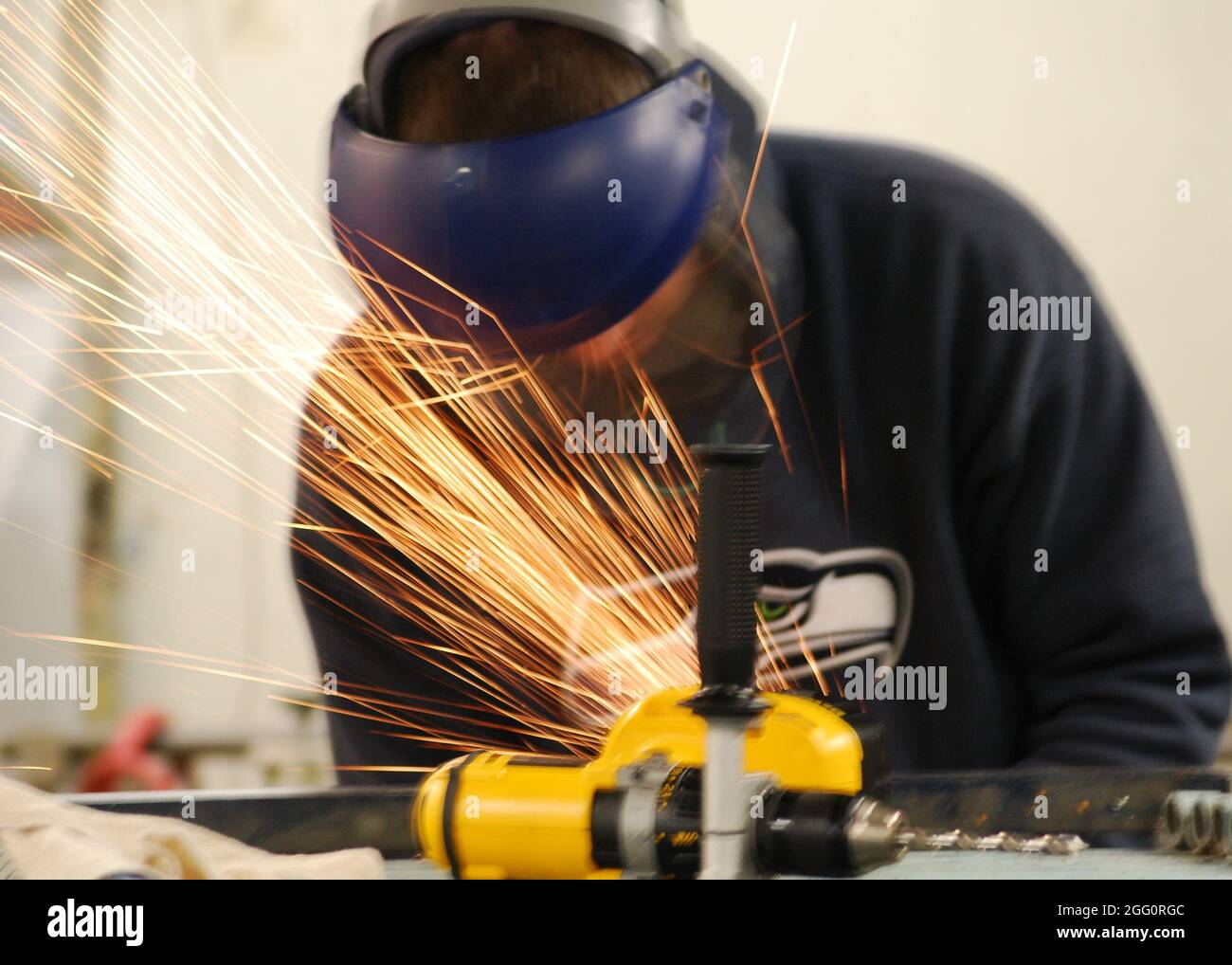 Worker grinding metal in a manufacturing plant Stock Photo - Alamy