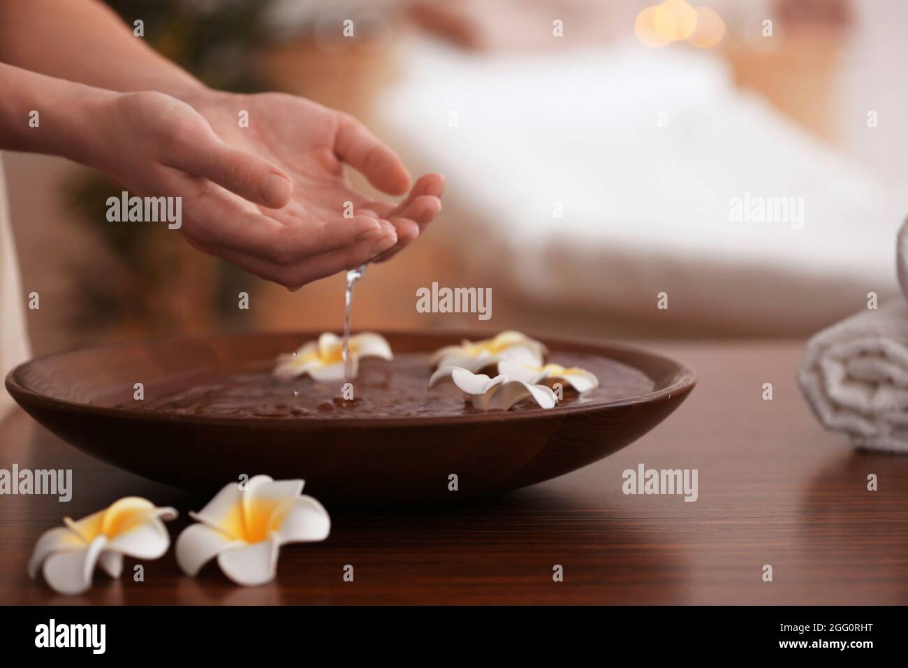 Spa concept. Female hands with bowl and exotic flowers Stock Photo - Alamy