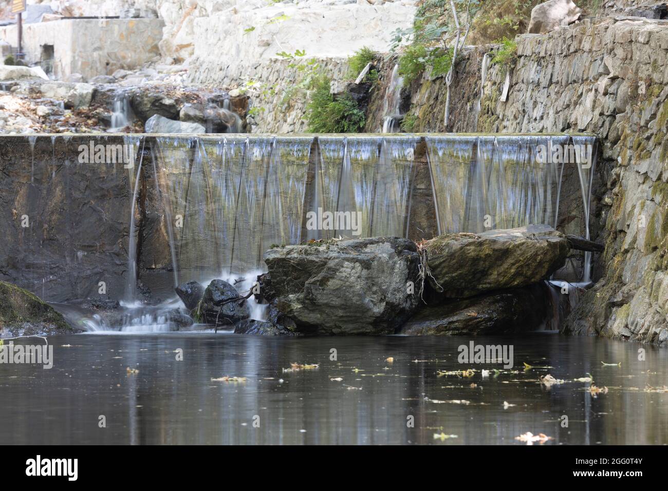 Stream flowing over concrete dam. In nature. clean Stock Photo - Alamy