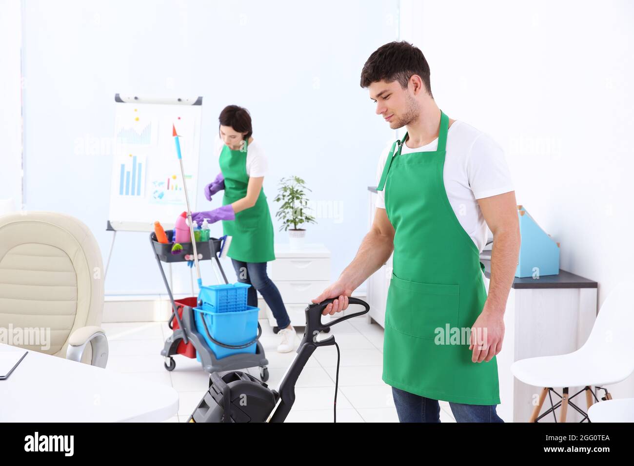 Service team cleaning modern office Stock Photo - Alamy