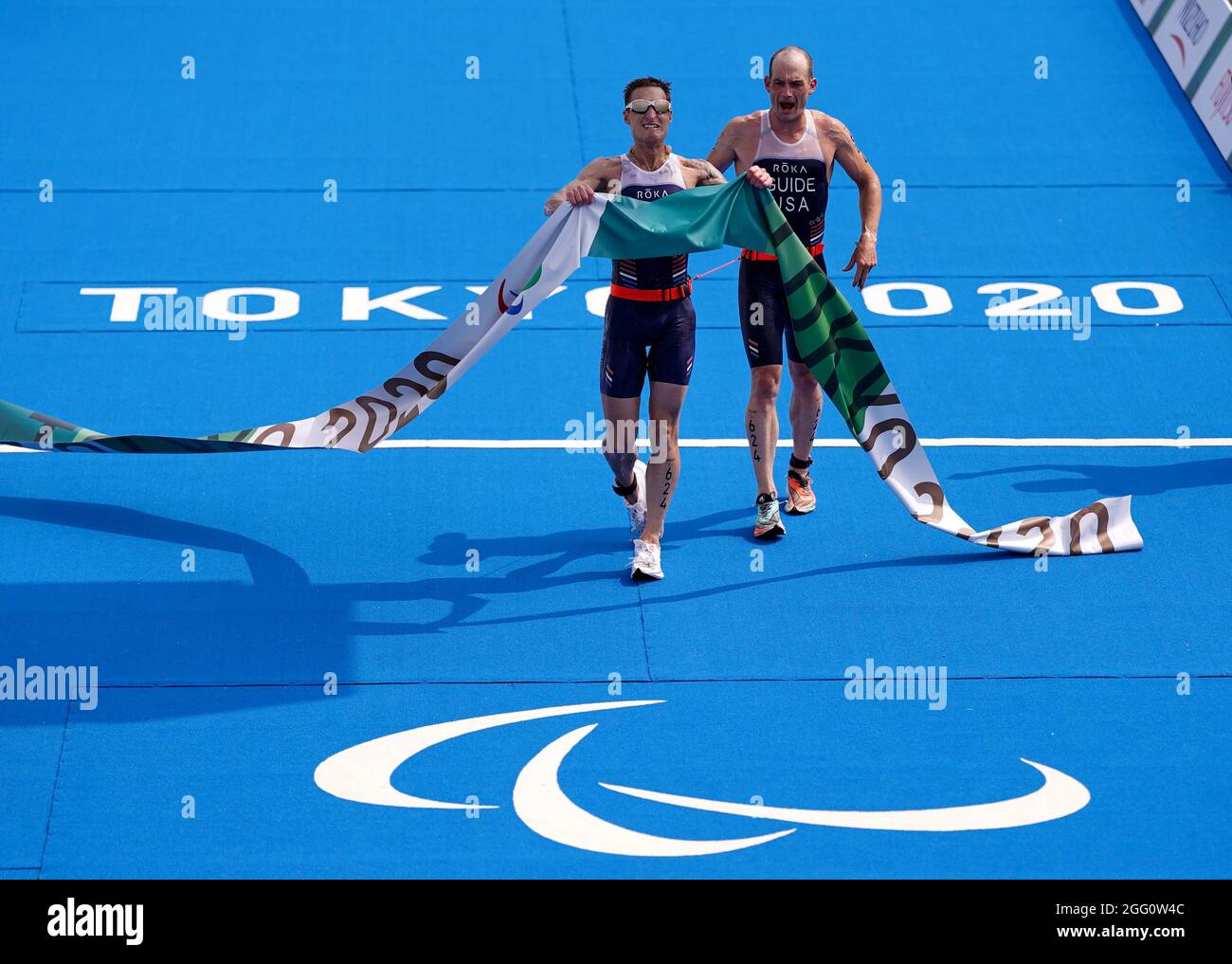 USA's Brad Snyder and guide Greg Billington cross the line to win gold ...
