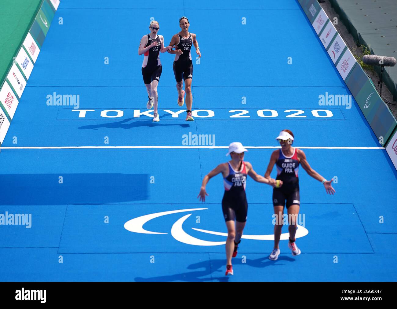 Great Britain's Alison Peasgood and guide Nikki Bartlett cross the line ...