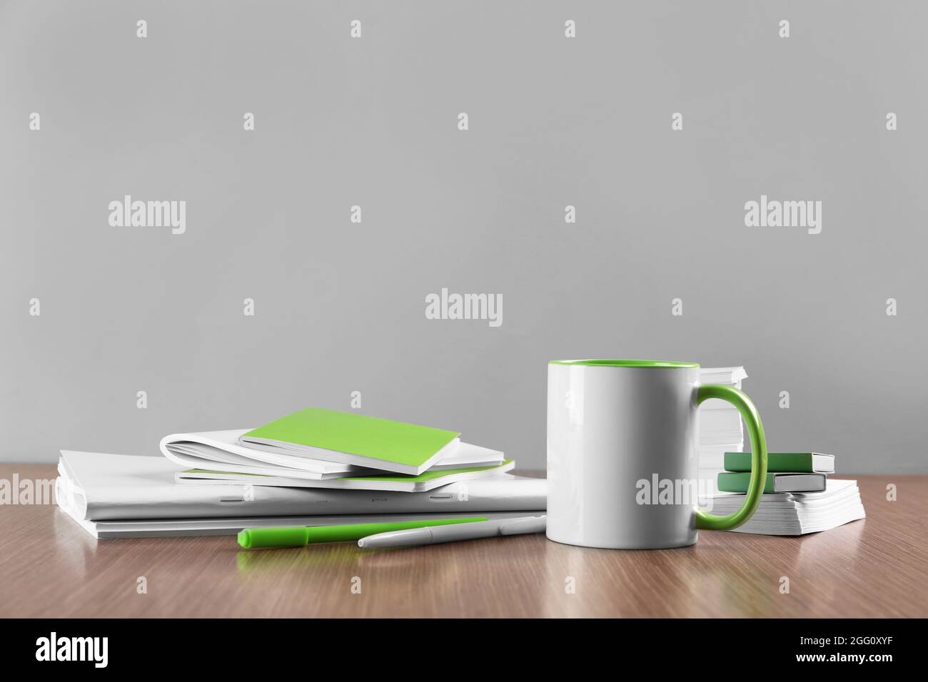 Blank goods on wooden table and grey background Stock Photo - Alamy