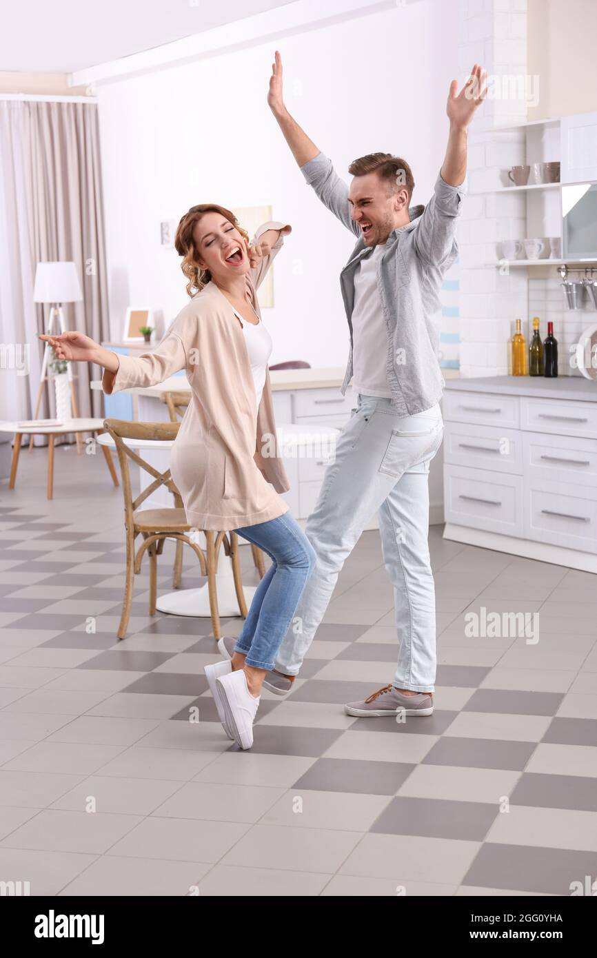 Cute young couple dancing at home Stock Photo - Alamy