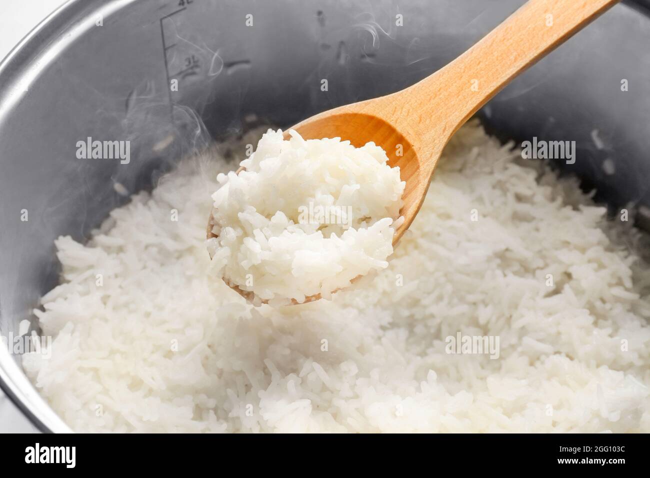 Mixing rice in metal pan, closeup Stock Photo - Alamy