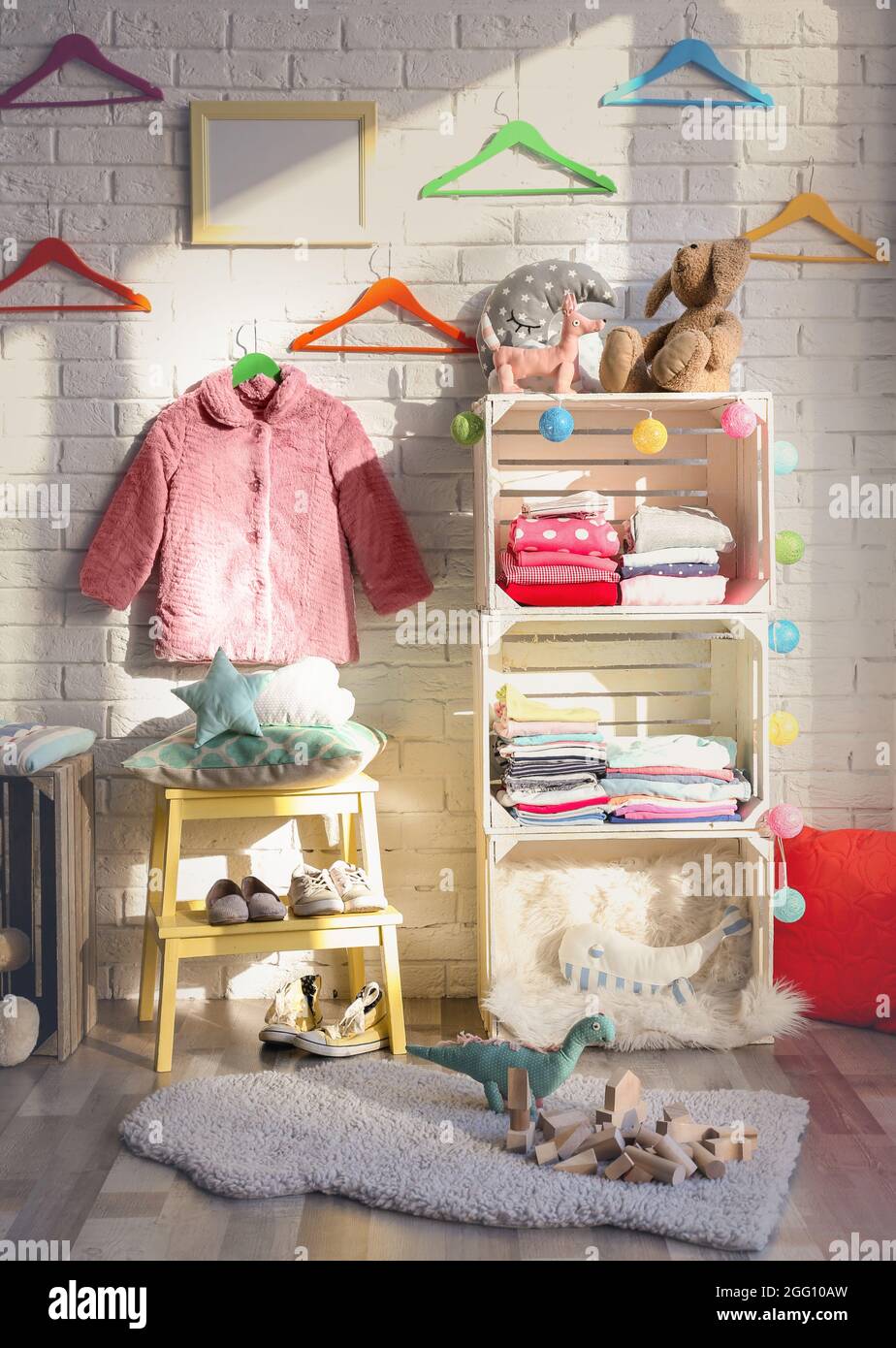 Clothes on shelf in kids room Stock Photo - Alamy