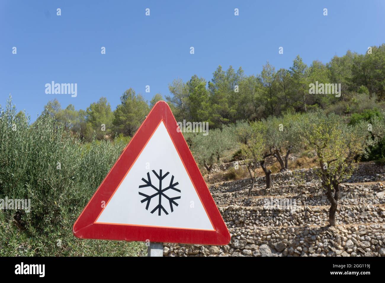 Warning sign of a different season snow in summer Stock Photo - Alamy