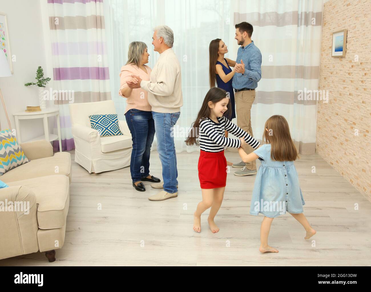 Happy big family dancing in the room Stock Photo - Alamy