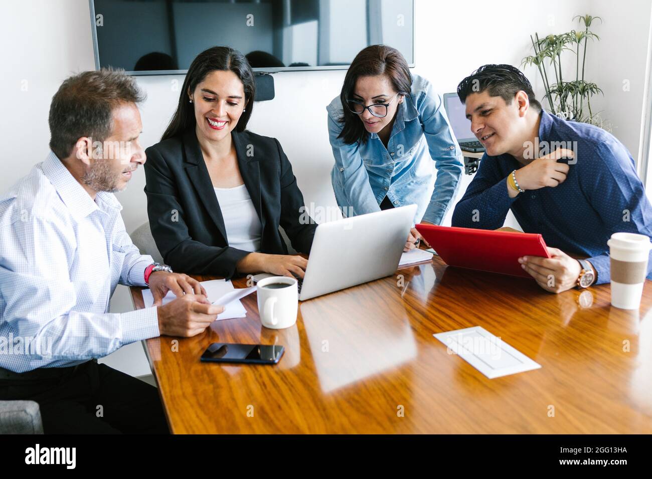 Mexican people in business meeting using computer in office in Latin ...