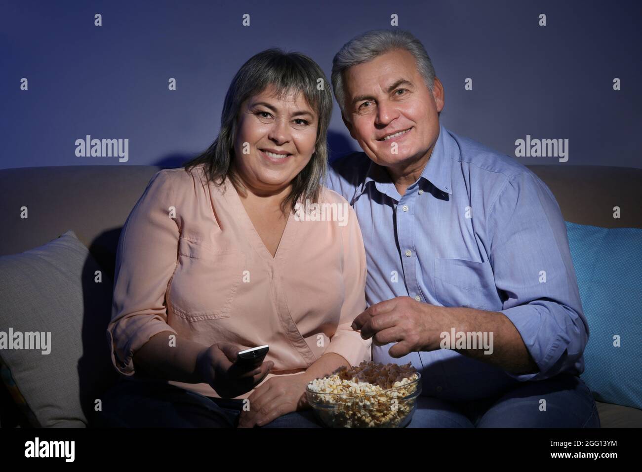 Middle aged couple watching TV at home Stock Photo - Alamy