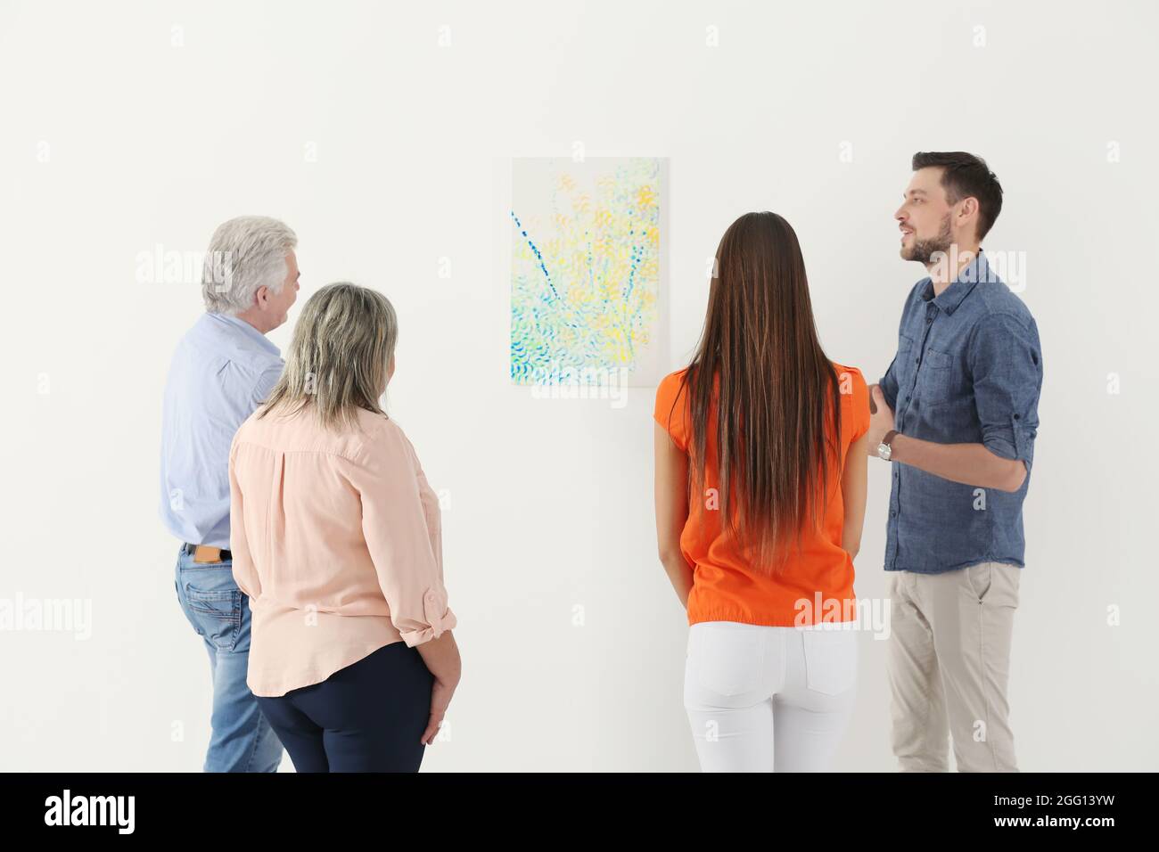 People looking at picture in art gallery Stock Photo - Alamy