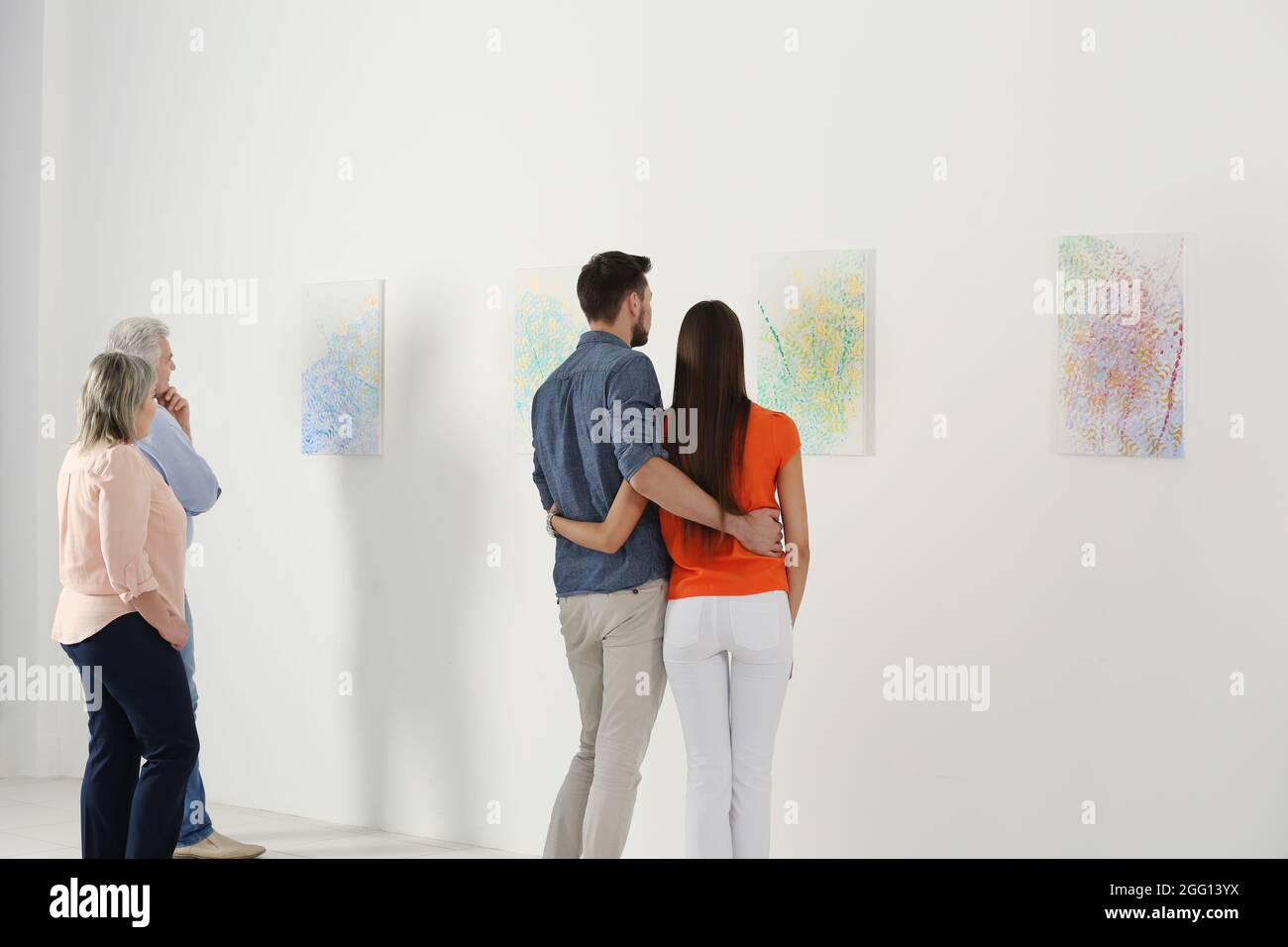 People looking at picture in art gallery Stock Photo - Alamy