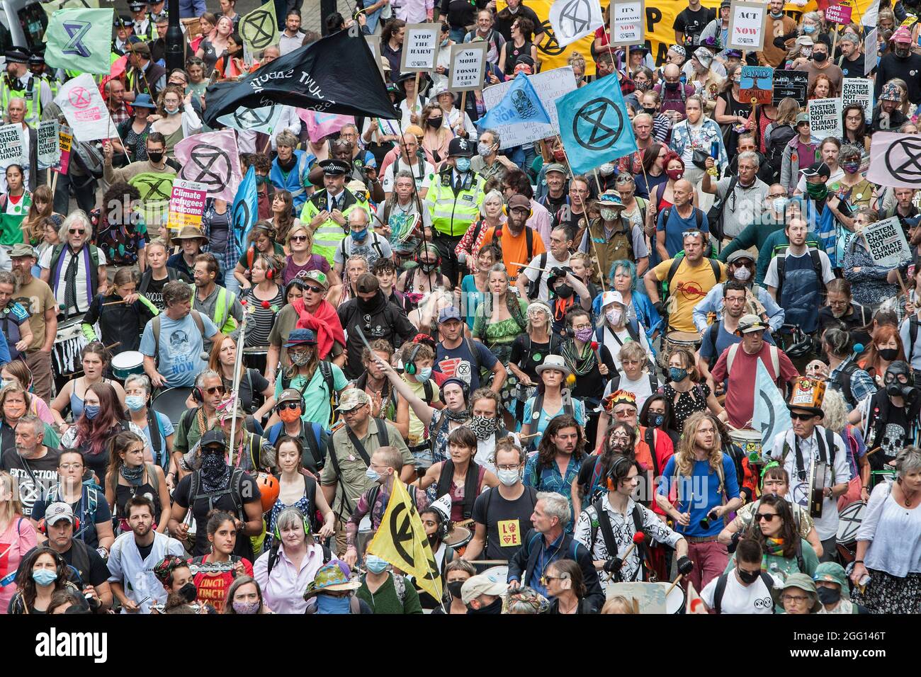 London, UK. 27th Aug, 2021. Rebels with flags drums and signs march ...