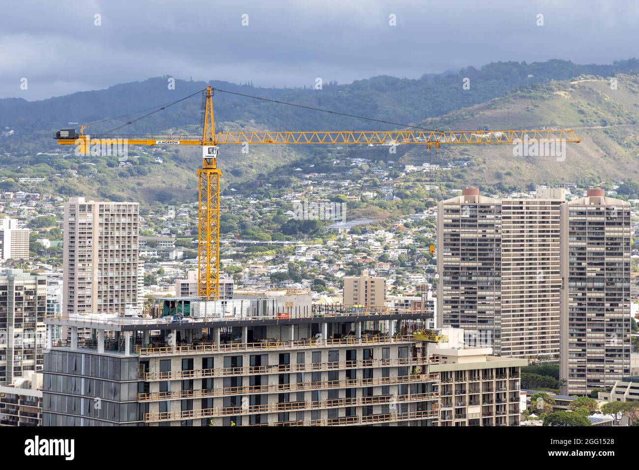 Construction crane over city in Honolulu, Hawaii Stock Photo - Alamy