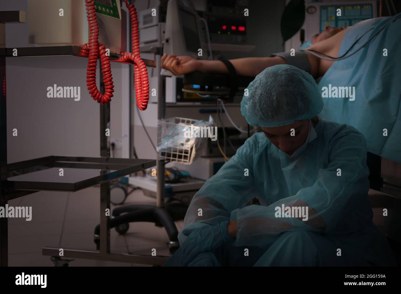 Sad doctor sitting on floor after failed operation in clinic Stock ...