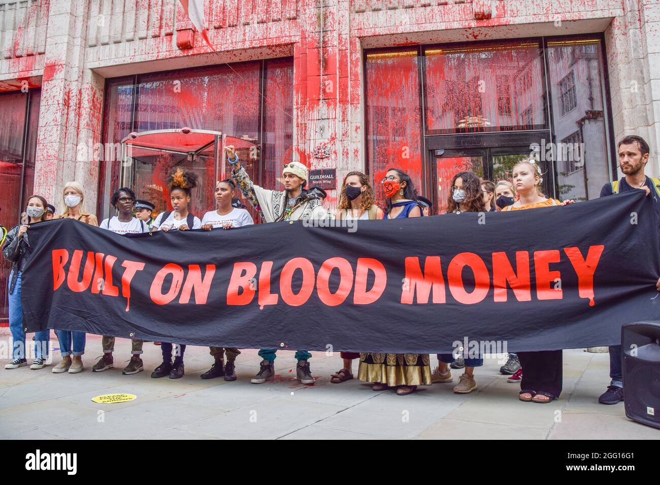 London, UK. 27th Aug, 2021. Protesters hold a 'Built On Blood Money ...