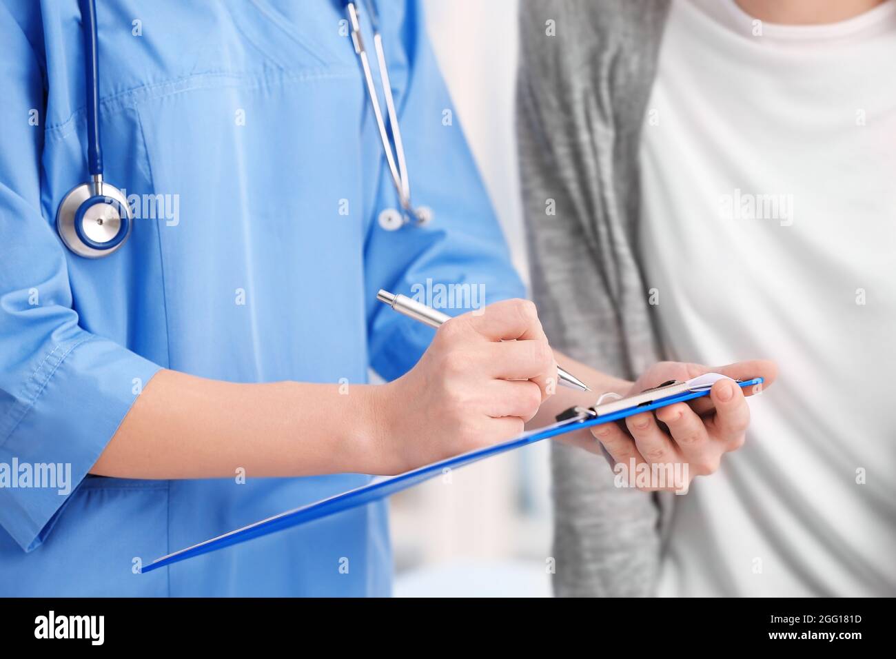Doctor writing out prescription for patient, closeup Stock Photo - Alamy
