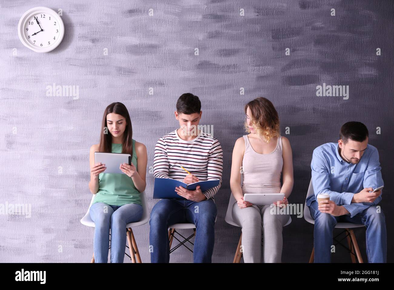 Group of people waiting for interview in office corridor Stock Photo ...