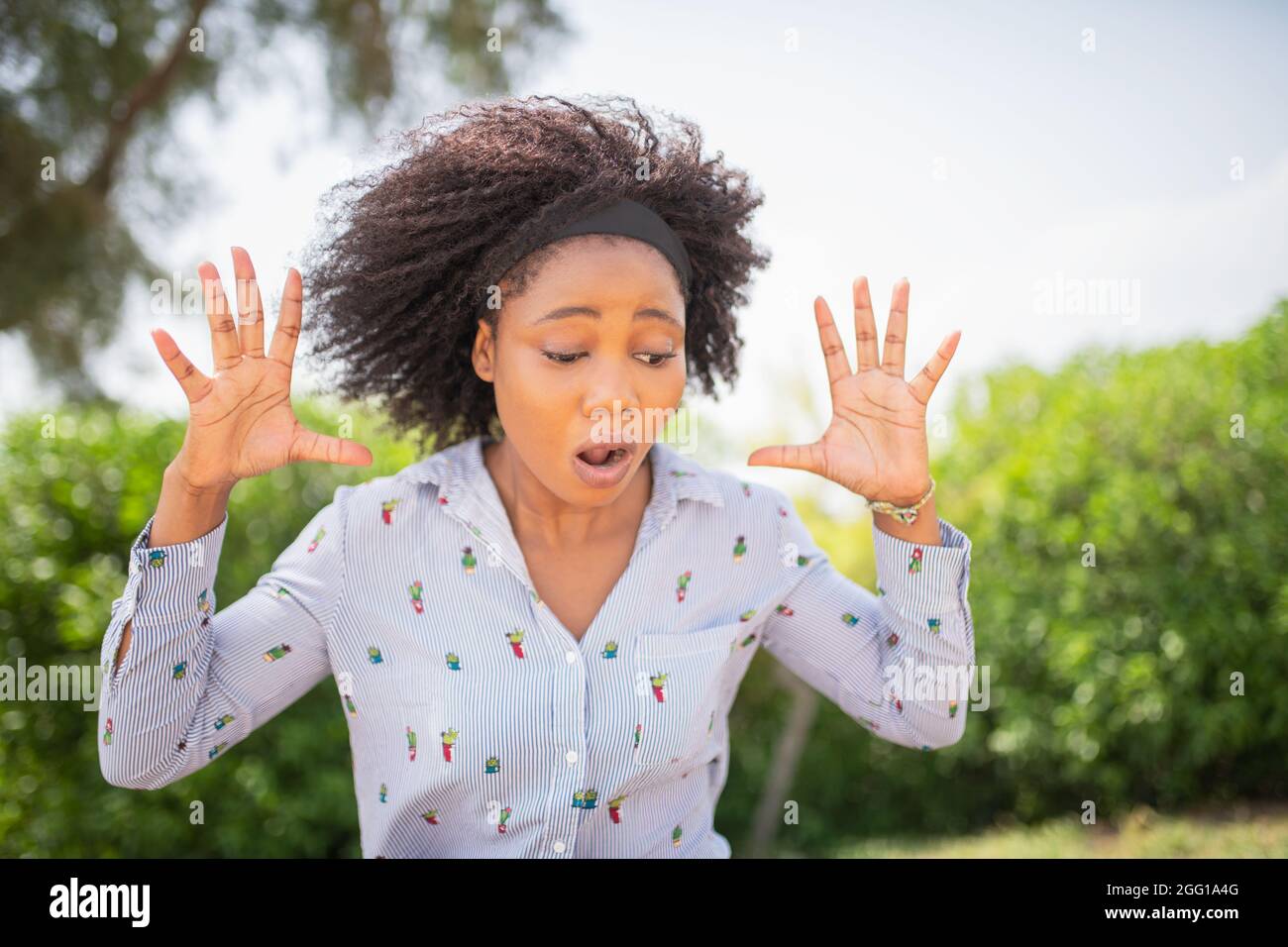 Young shocked woman looking down with a surprised expression on her ...