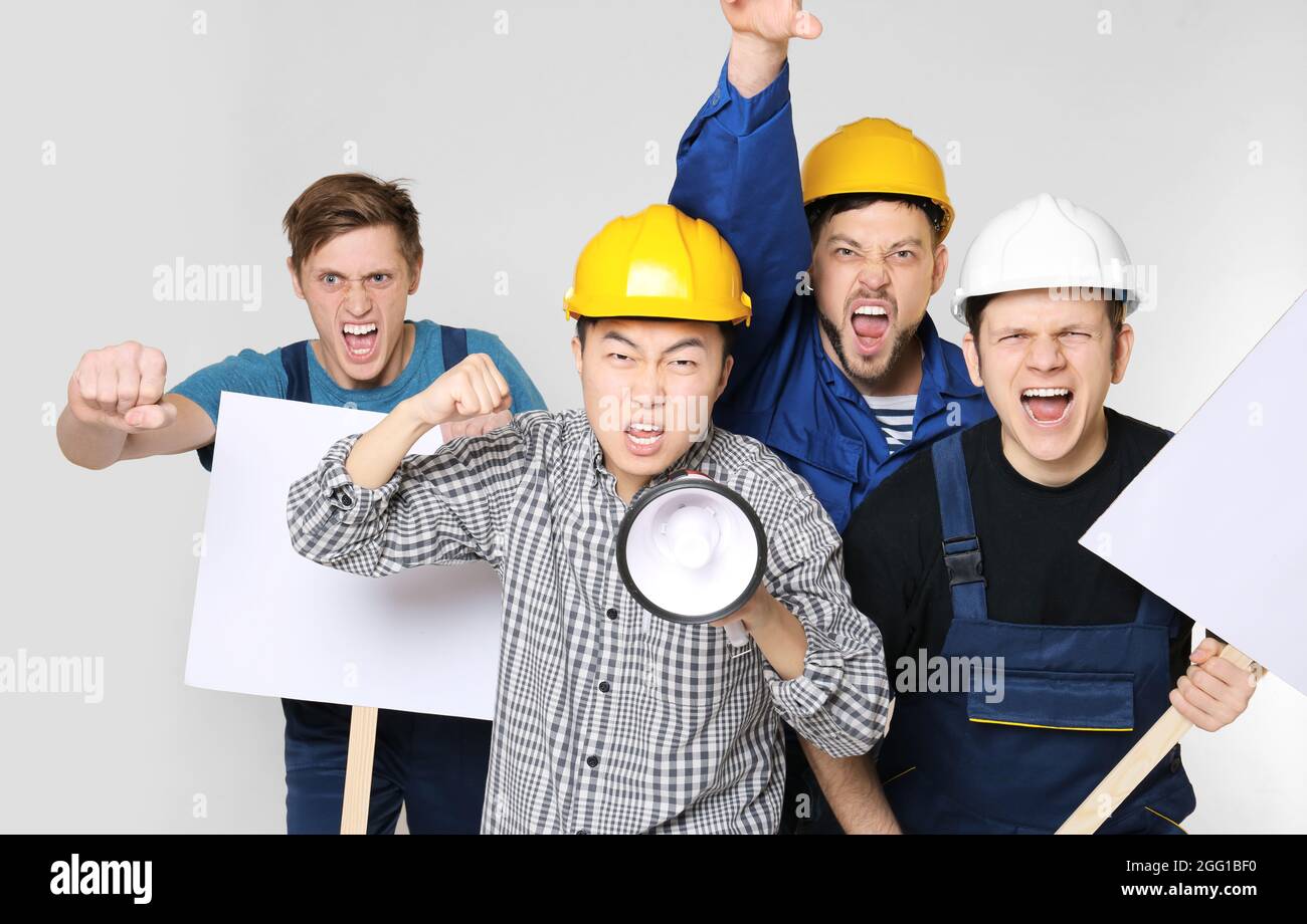 Group of protesting young men on light background Stock Photo - Alamy